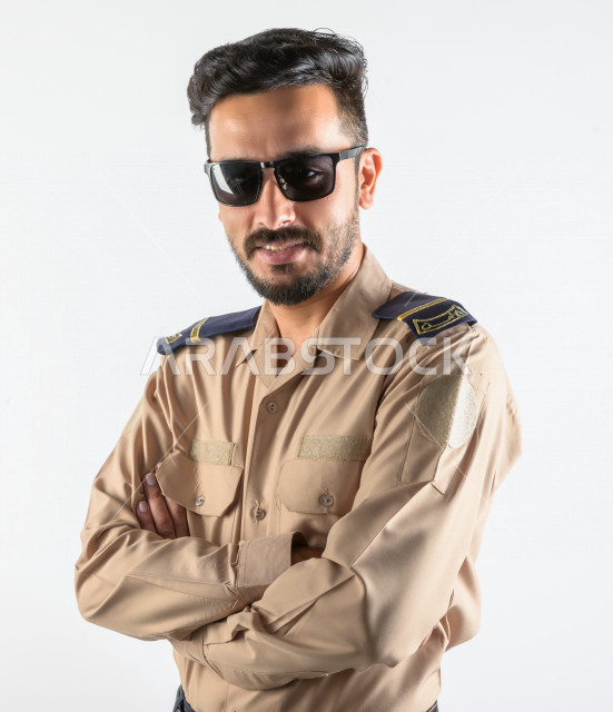 Portrait of a Saudi Arabian Gulf man working as a security man, wearing ...