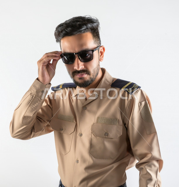Portrait of a Saudi Arabian Gulf man working as a security man, wearing ...