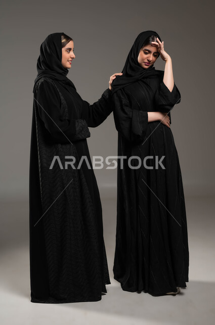 Support between sisters, a portrait of a veiled Saudi Arabian Gulf girl ...