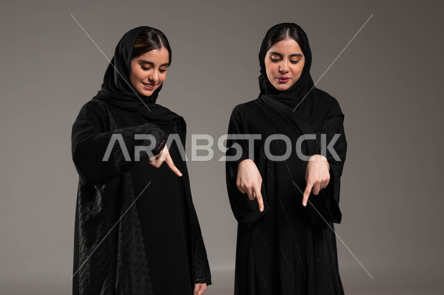 Looking and pointing with the fingers down at something with gestures ...