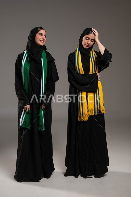 Wearing cheerleading scarves for football teams, a portrait of a veiled ...