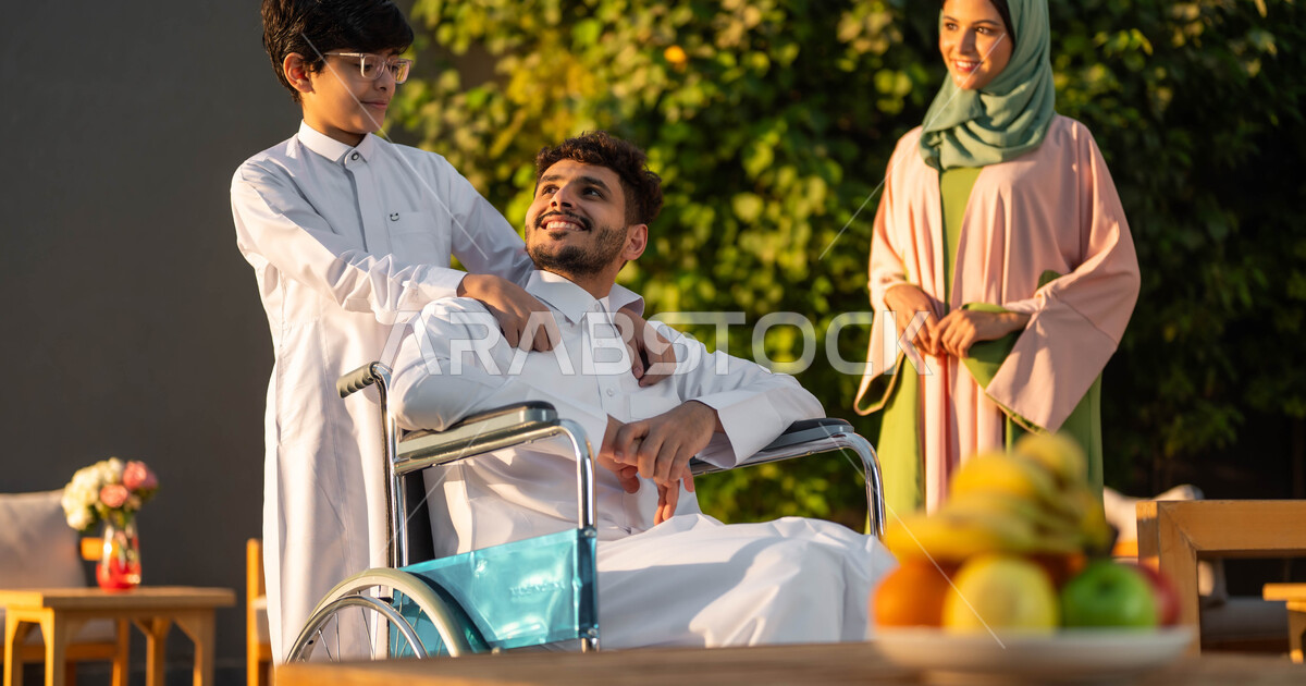 A smiling, crippled Saudi Gulf Arab man wearing a traditional thobe ...