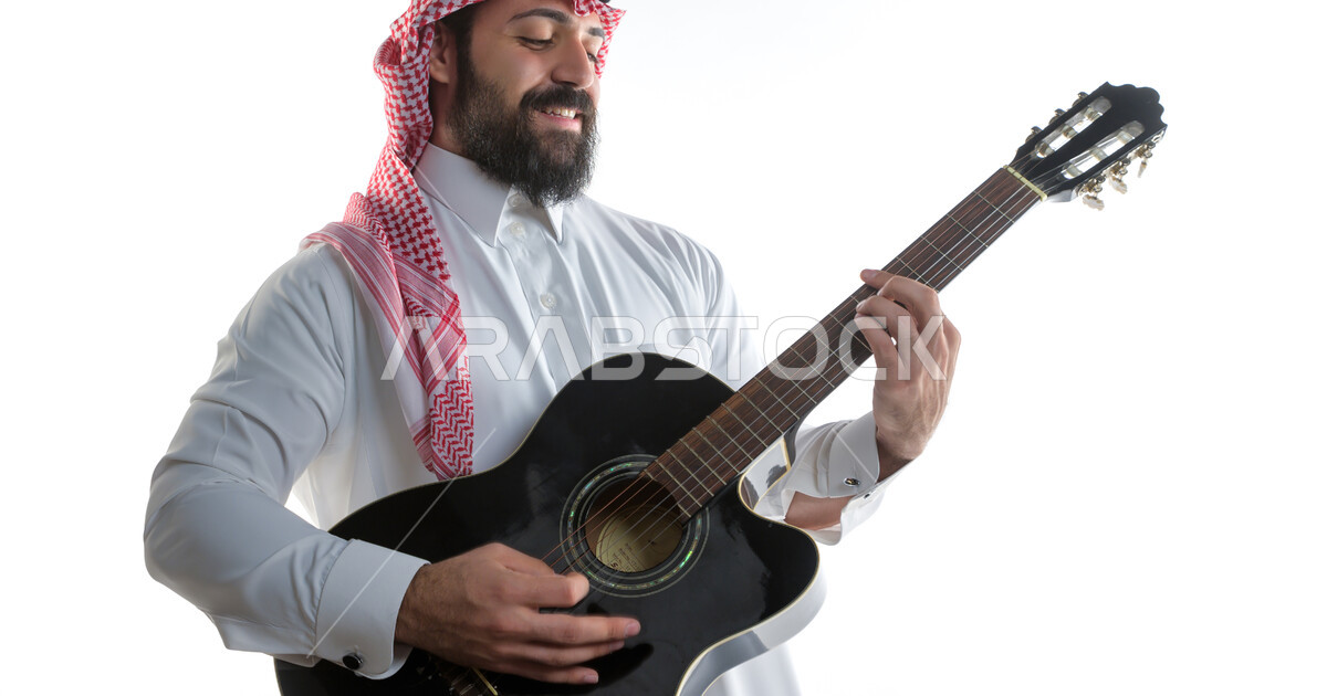 Portrait of a young Saudi Arab from the Gulf playing the guitar (a ...