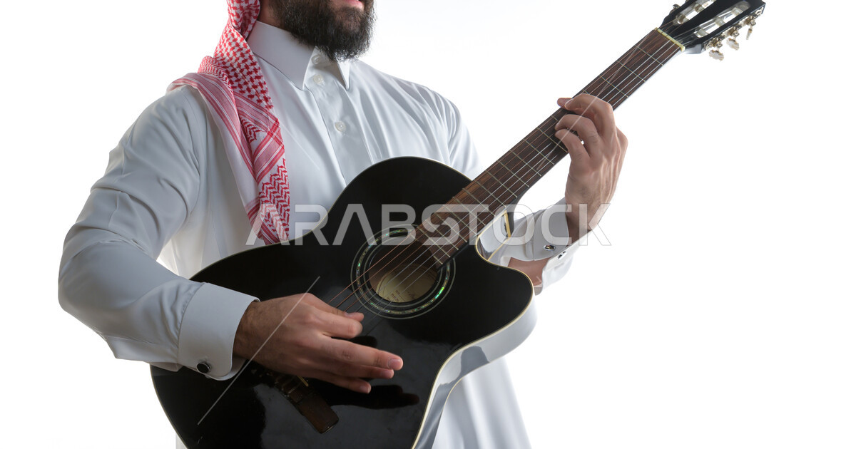 Portrait of a young Saudi Arab from the Gulf playing the guitar (a ...