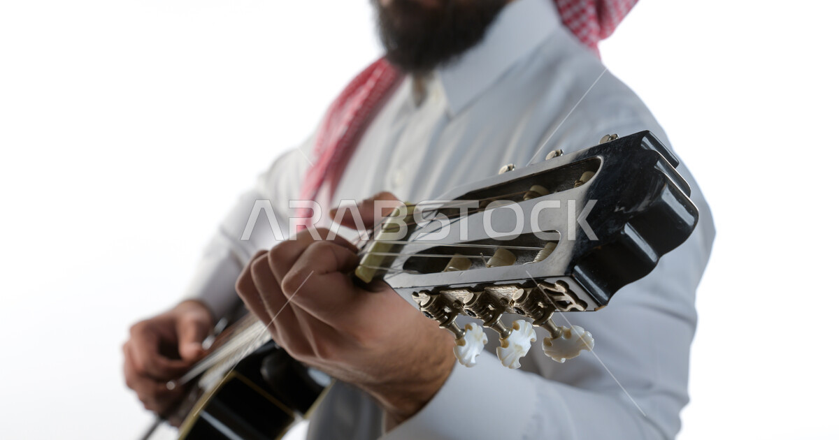 Portrait of a young Saudi Arab from the Gulf playing the guitar (a ...