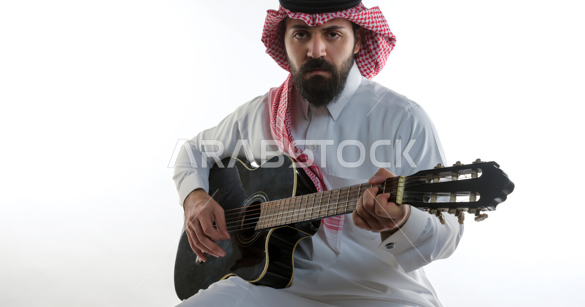 Portrait of a young Saudi Arab from the Gulf playing the guitar (a ...
