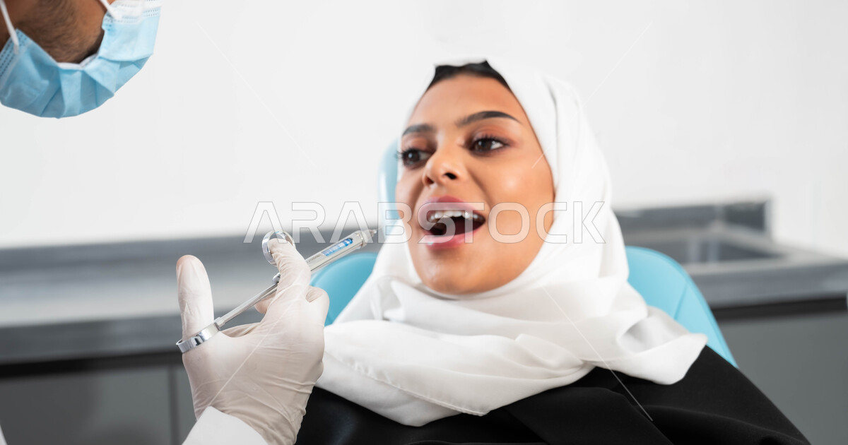 The concept of oral health care, a dentist wearing gloves and a medical ...
