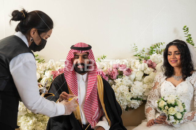 A Saudi Gulf Arab groom wearing a formal uniform and a traditional ...