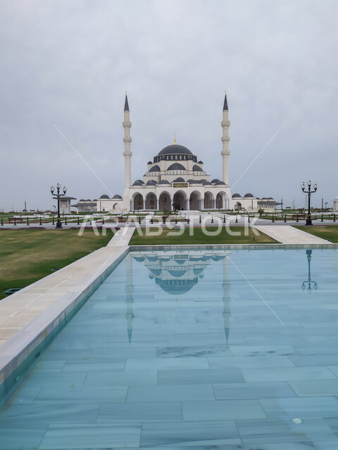 A close-up of a water pond in front of the Grand Mosque of Sharjah in ...