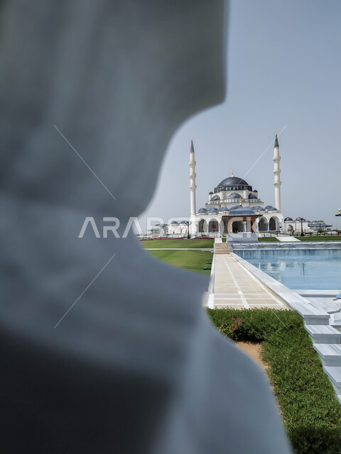 A close-up of a water pond in front of the Grand Mosque of Sharjah in ...