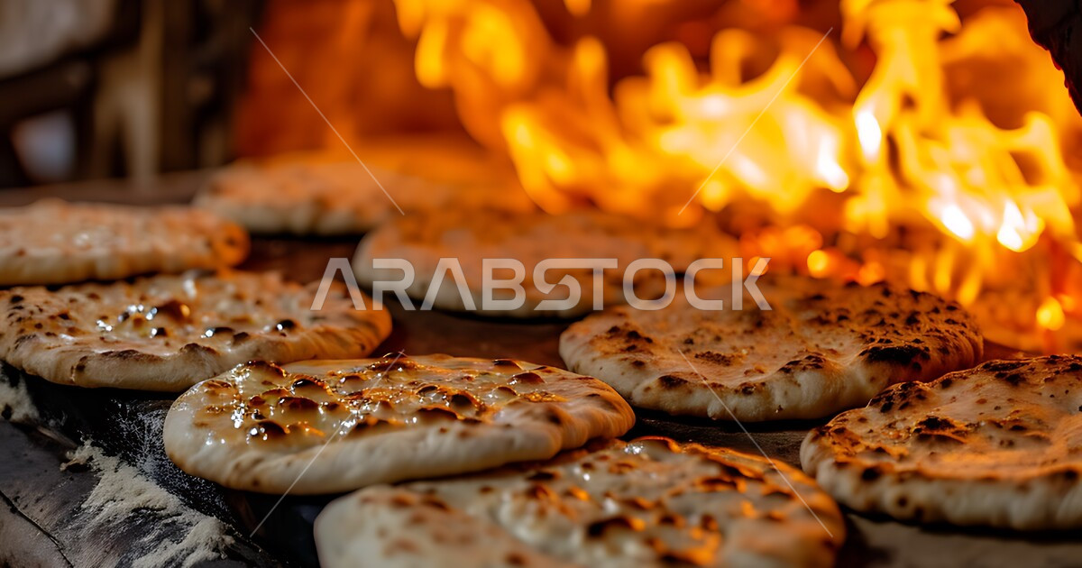 Fresh hot baked goods, a close-up of loaves of traditional Saudi bread ...