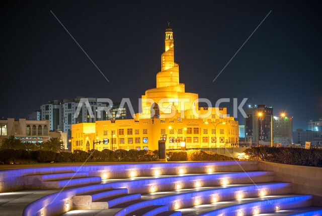The spiral Al-Fanar Mosque illuminated at night in the city of Doha ...
