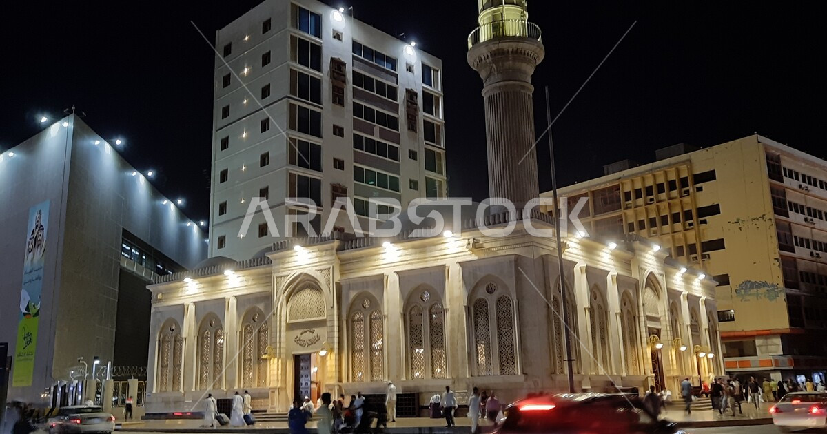 Car traffic on the roads and streets, the illuminated Al Mahmal Mosque ...