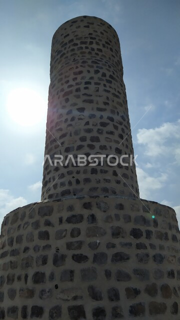 A close-up photo of the ancient stone-built Al-Adwani Tower in the city ...