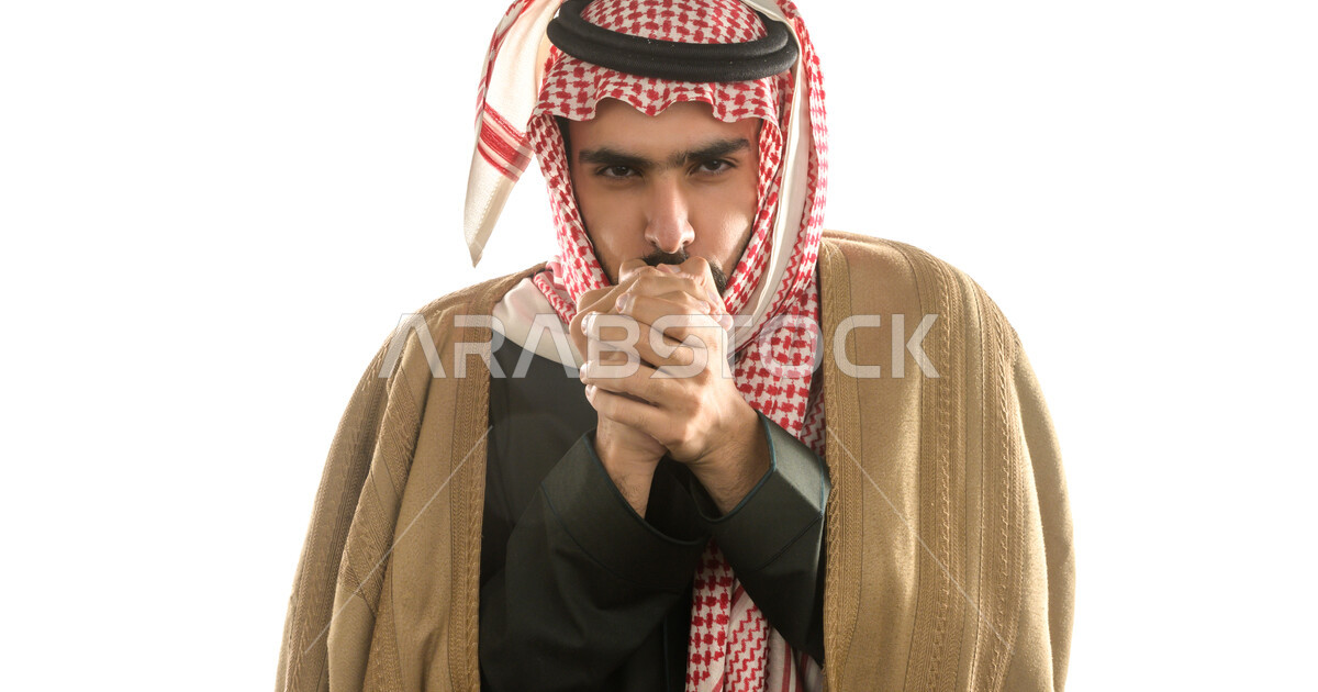 Portrait of a Saudi Gulf man with face gestures indicating feeling cold ...