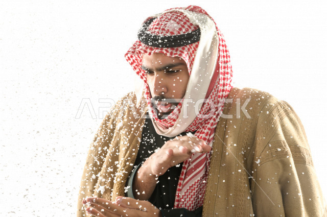 Portrait of a Saudi Gulf man happy with snowfall, facial gestures ...