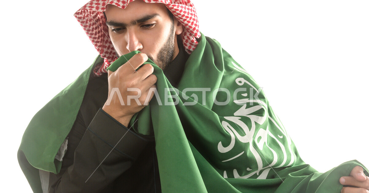 Portrait of a Saudi man holding the Saudi flag on the Saudi National ...
