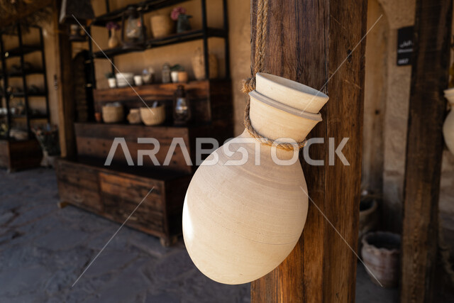 Shops in the old town market in AlUla, a close-up of a pottery jar ...