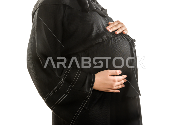 Portrait of a pregnant Saudi Arabian Gulf woman wearing a maternity ...