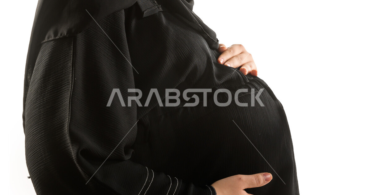 Portrait of a pregnant Saudi Arabian Gulf woman, wearing a maternity ...
