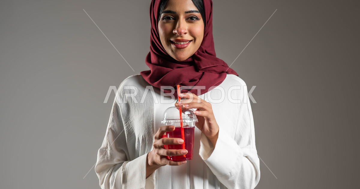 Fresh fruit juices, close-up portrait of a Saudi Gulf Arab woman ...