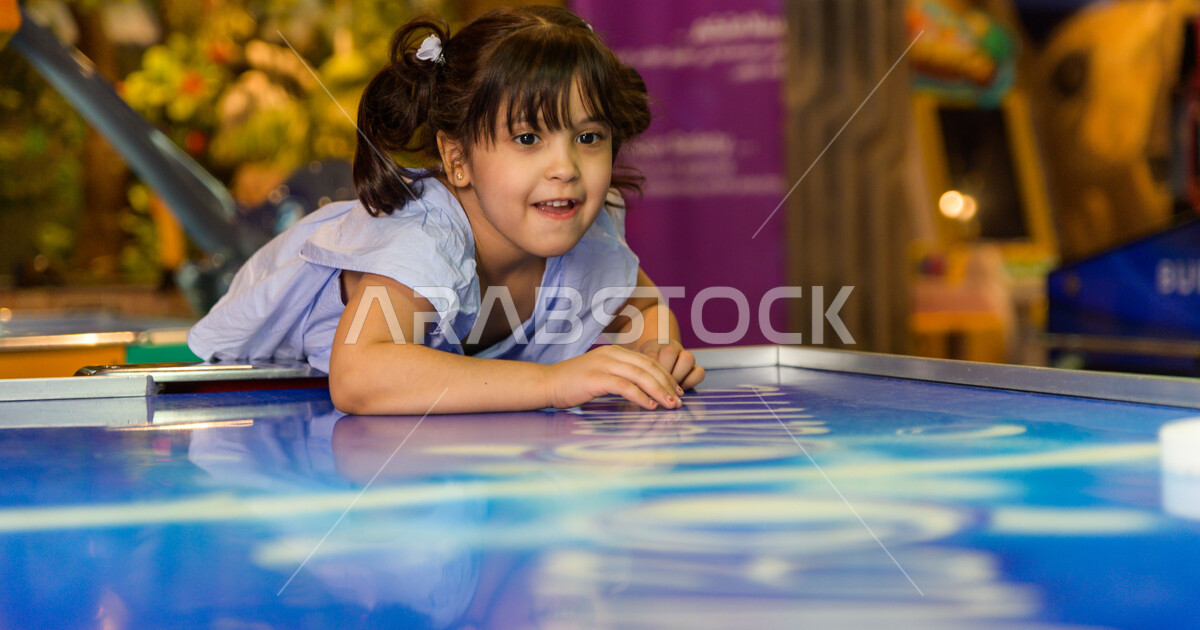 A Saudi girl in the city of games, playing many different electronic ...