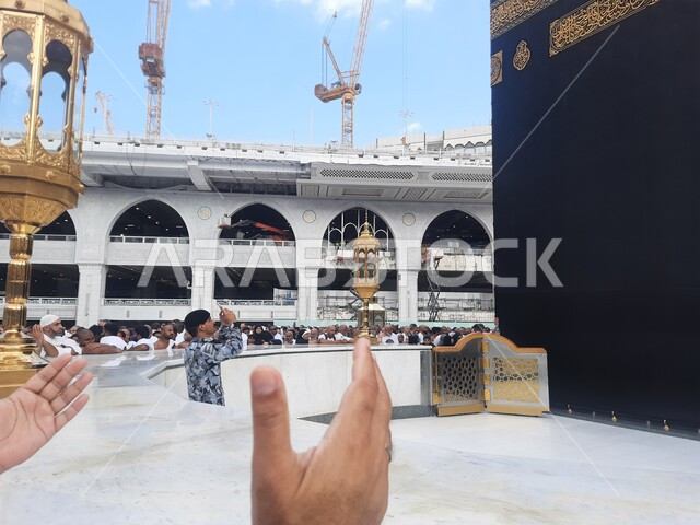 Performing Hajj and Umrah rituals, a close-up of the hand of a Saudi ...