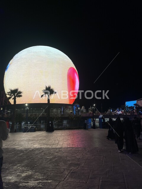 The giant illuminated ball event at night, planting trees and green ...