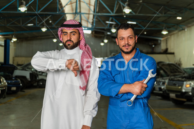 A Saudi Arab man stands with the mechanical engineer inside the auto ...