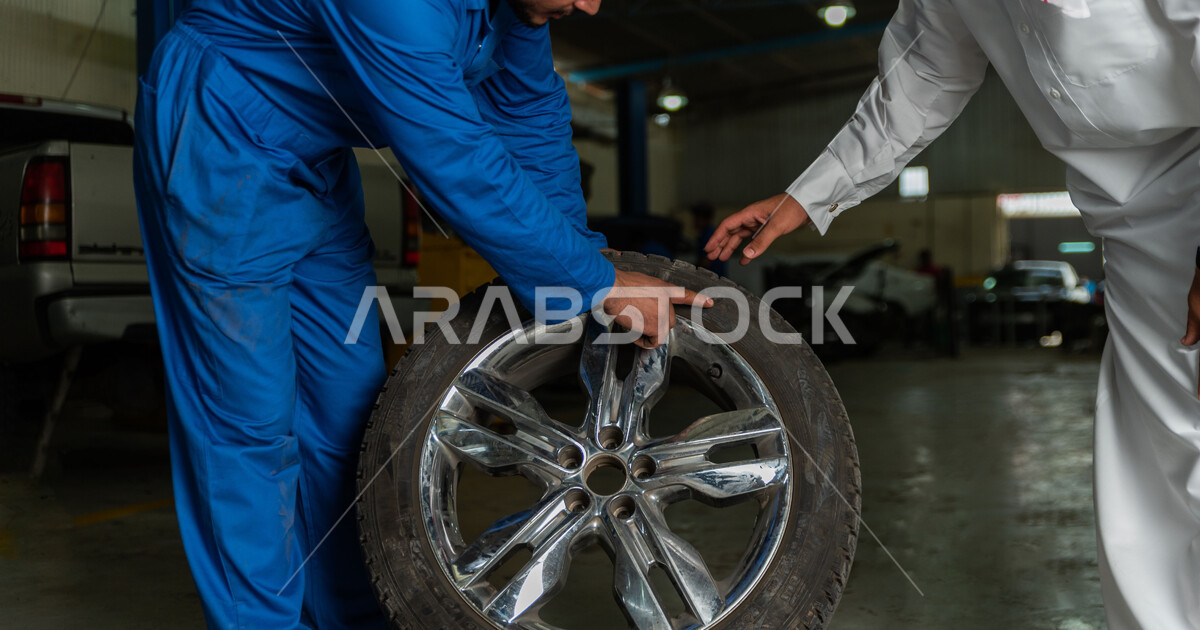 A Saudi Arab man stands with the mechanical engineer inside the auto ...