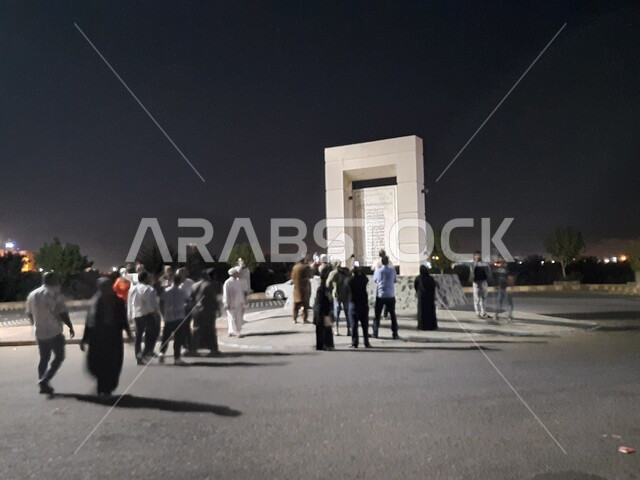 Visitors gathered around the sign introducing the names of the martyrs ...