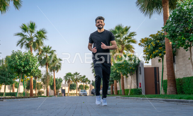 Health and fitness, a Saudi Gulf Arab man doing morning exercises ...