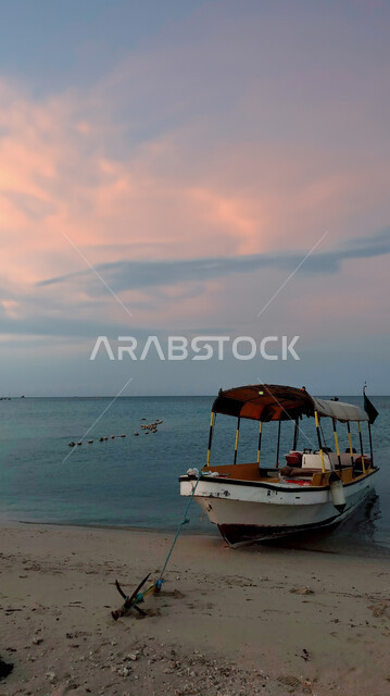 Enjoying the natural scenery at sunset, a boat standing on the beach on ...