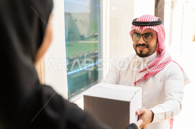 A young Saudi Arabian Gulf man works on delivering orders, delivering ...