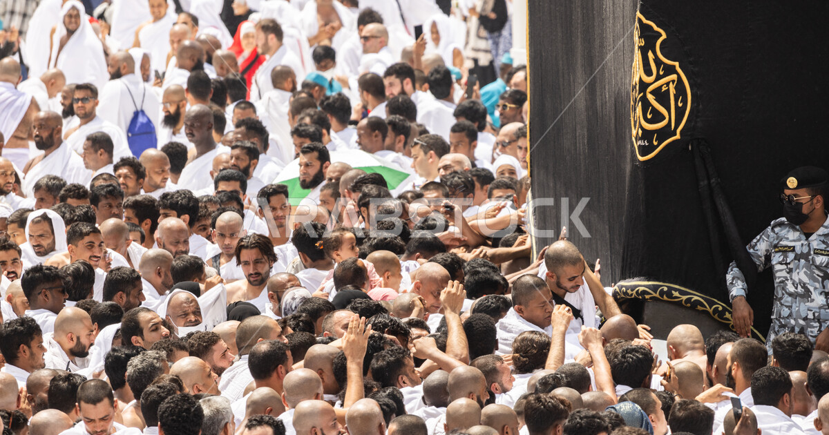 Islamic holy places, close-up of pilgrims near the Holy Kaaba in the ...