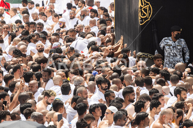 Islamic holy places, close-up of pilgrims near the Holy Kaaba in the ...
