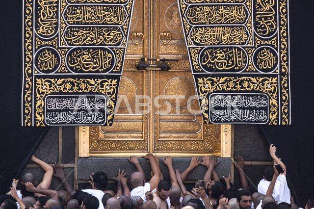 Islamic holy places, close-up of pilgrims near the Holy Kaaba door in ...