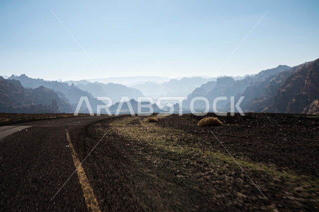 A close-up photo of paved roads in the middle of mountainous nature ...