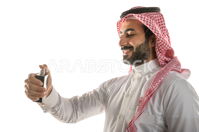 Portrait of a young Saudi Arabian Gulf man wearing perfume, wearing ...