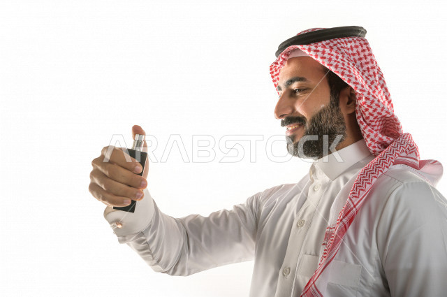Portrait of a young Saudi Arabian Gulf man wearing perfume, wearing ...