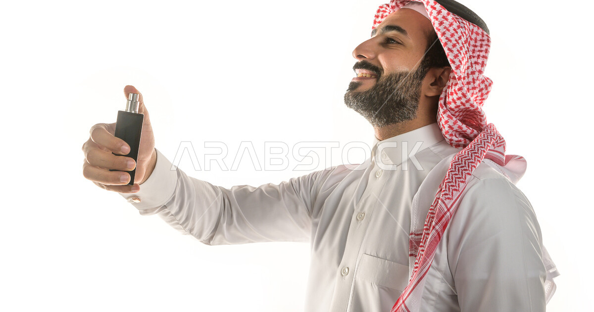 Portrait of a young Saudi Arabian Gulf man wearing perfume, wearing ...