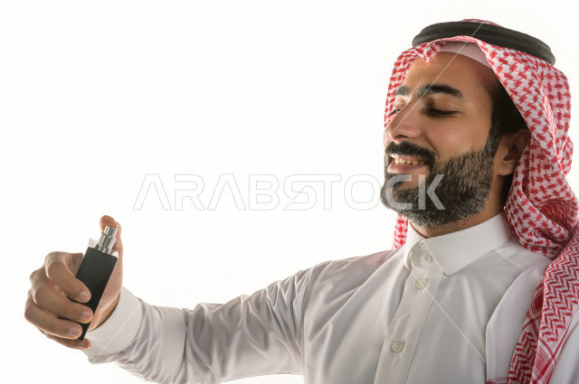 Portrait of a young Saudi Arabian Gulf man wearing perfume, wearing ...