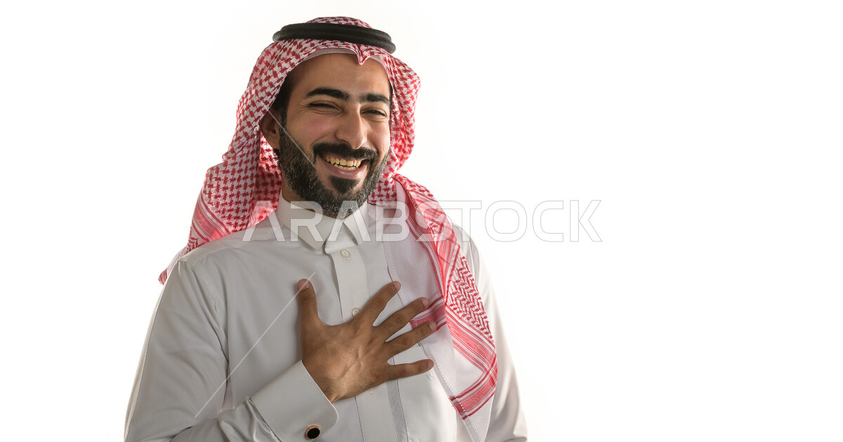 Portrait of a Saudi Gulf man laughing with facial gestures indicating ...