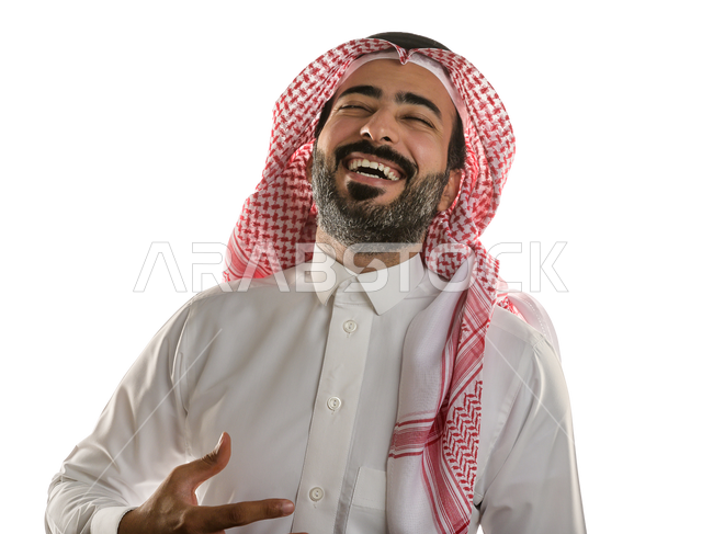 Portrait of a Saudi Gulf man laughing with facial gestures indicating ...