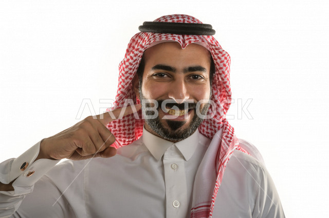 Portrait of a Saudi Gulf man laughing with facial gestures indicating ...