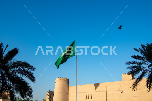 The flagpole of the Saudi national flag flying in the sky, the historic ...