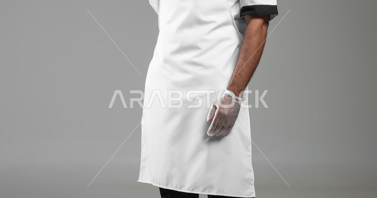 Portrait of a Saudi Arabian Gulf chef wearing a chef’s uniform, hand ...
