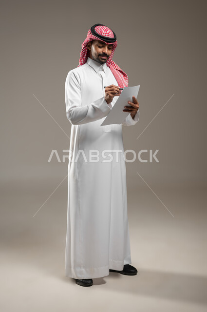 Full-length side photo of a Saudi Gulf Arab man wearing Saudi uniform ...