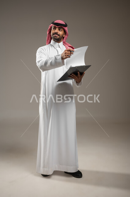 A full-length portrait of a Saudi Gulf Arab man wearing Saudi uniform ...