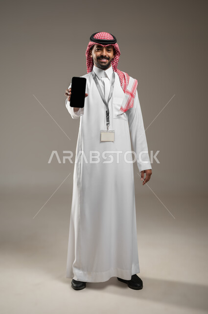 A full-length portrait of a Saudi Gulf Arab man wearing Saudi uniform ...